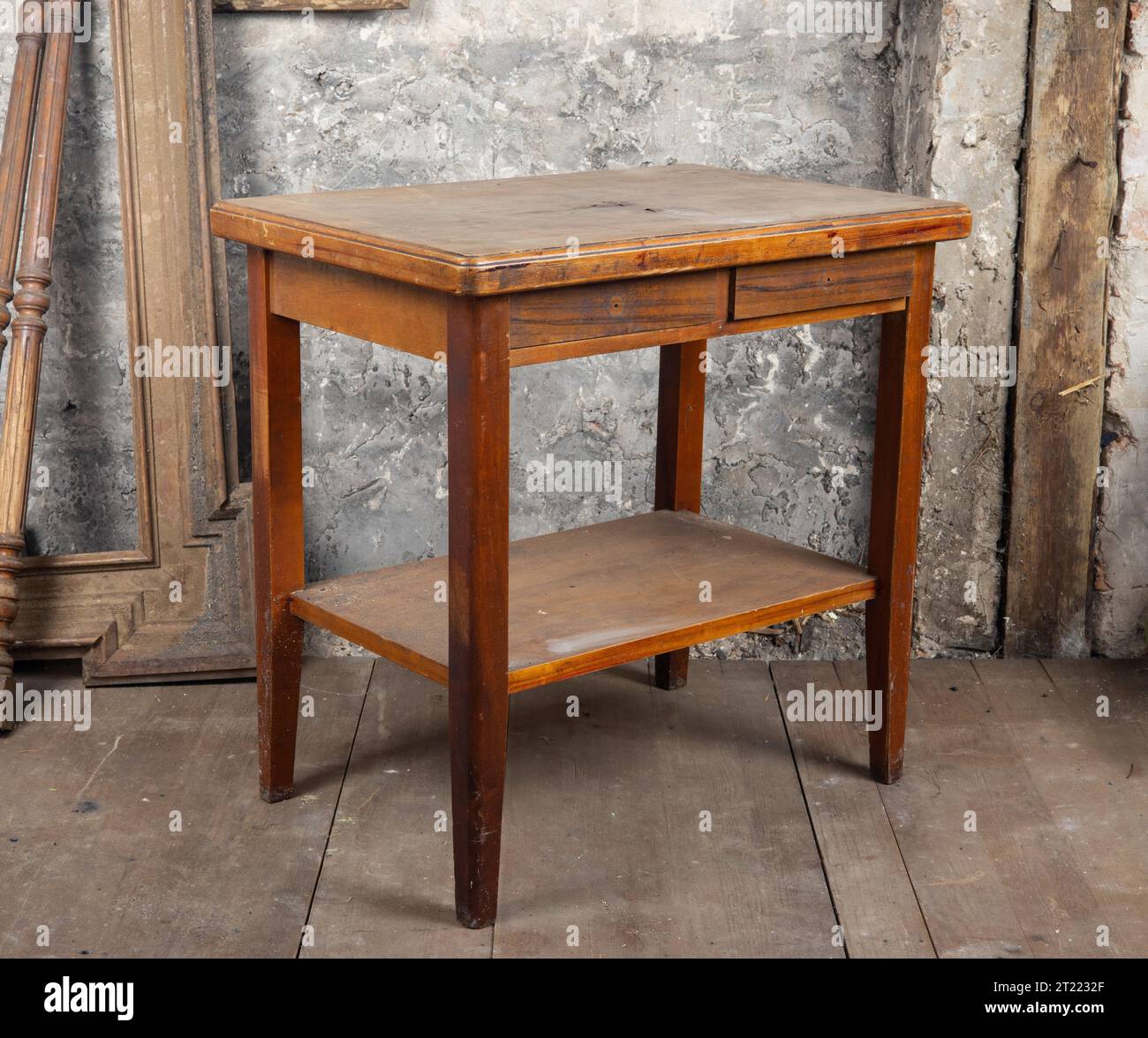 Vintage style . Defective old broken table in an old dirty room with ...