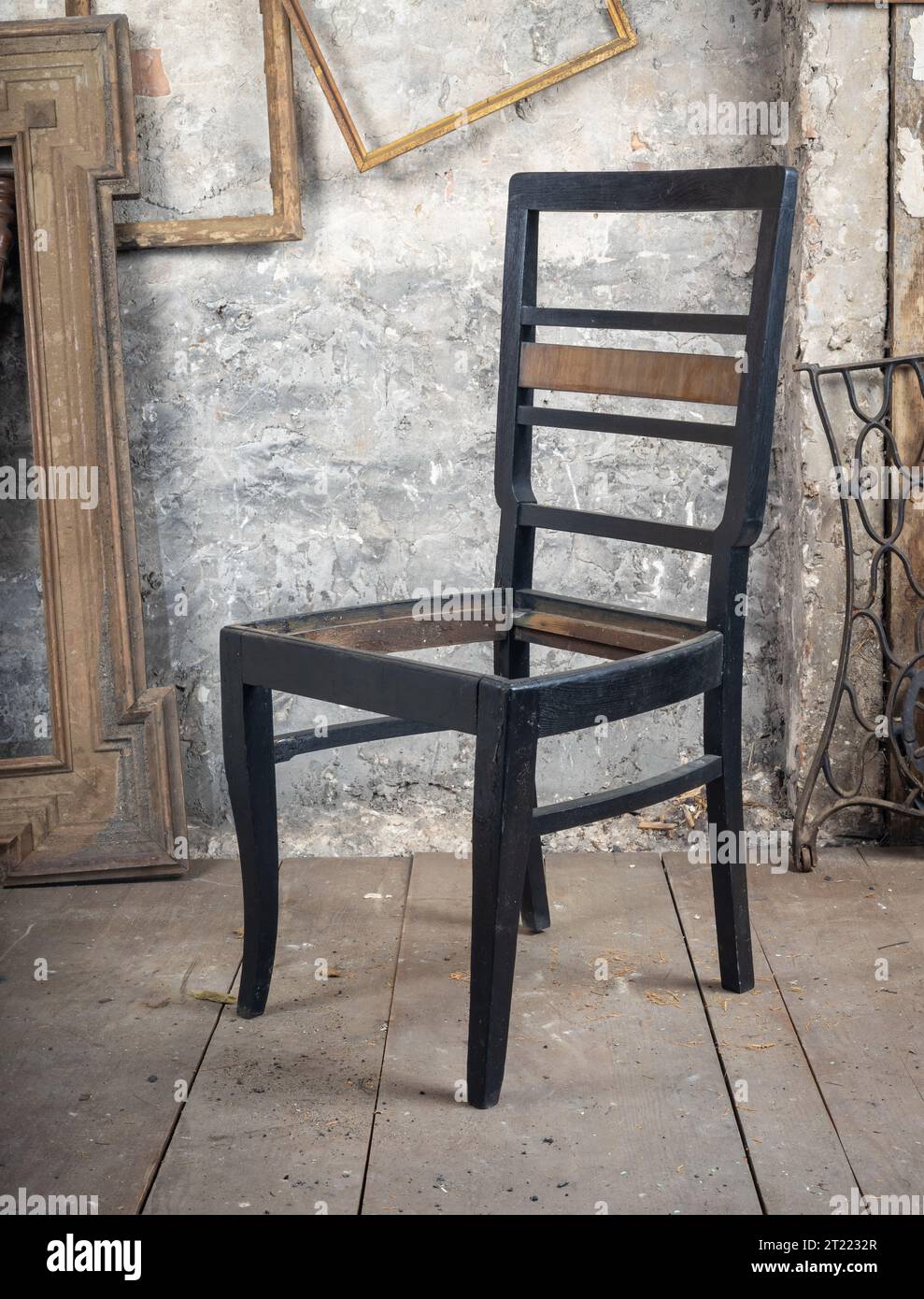 Vintage style . Defective old broken chair in an old dirty room with ...