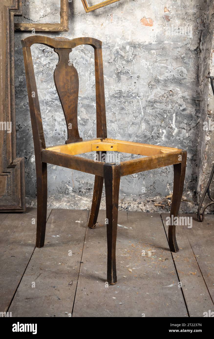 Vintage style . Defective old broken chair in an old dirty room with ...