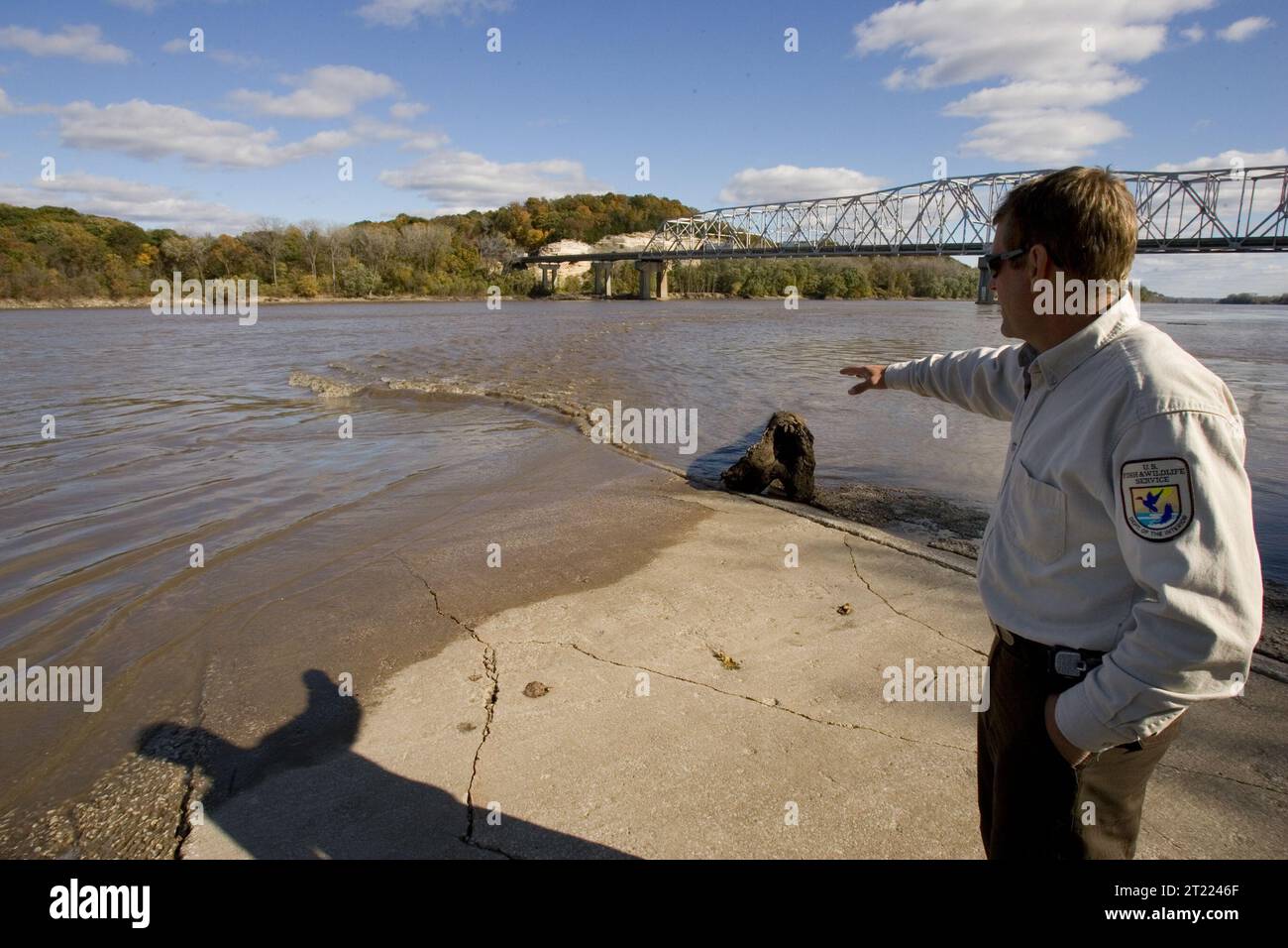 A U.S. Fish and Wildlife Service employee stands near the Missouri ...