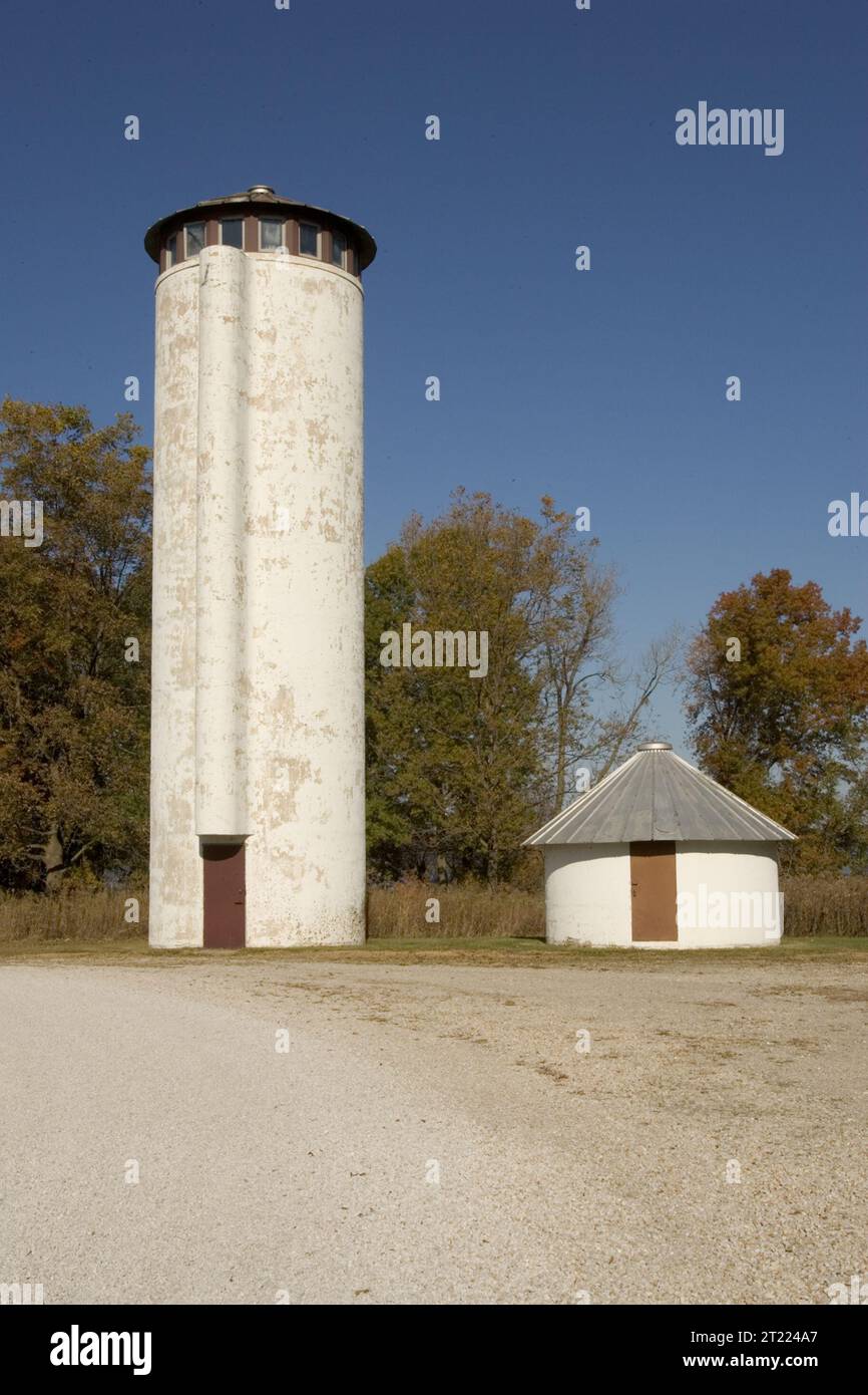 Tall white silo-shaped wildlife observation tower with viewing spaces ...