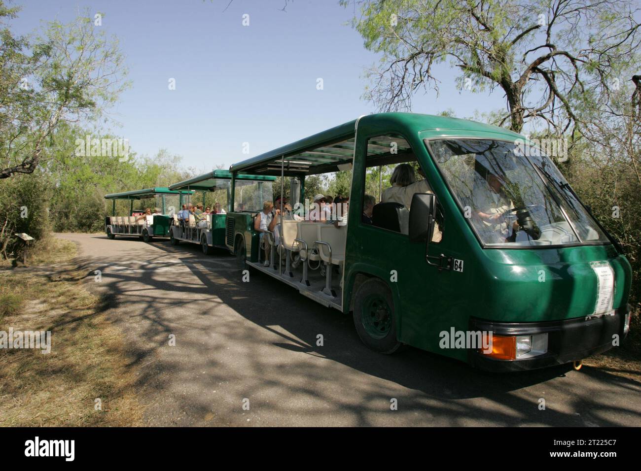 Visitors enjoy a wildlife tour aboard the open-air tram at Santa Ana ...
