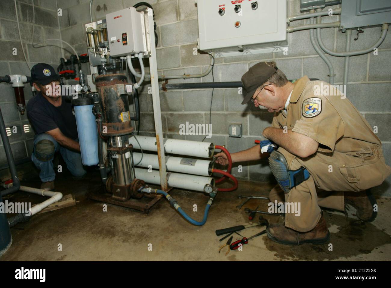 U.S. Fish and Wildlife Service employee and volunteer work on refuge ...