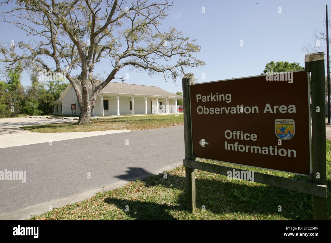 Direction sign and white office building for the refuge. Subjects: Logo ...