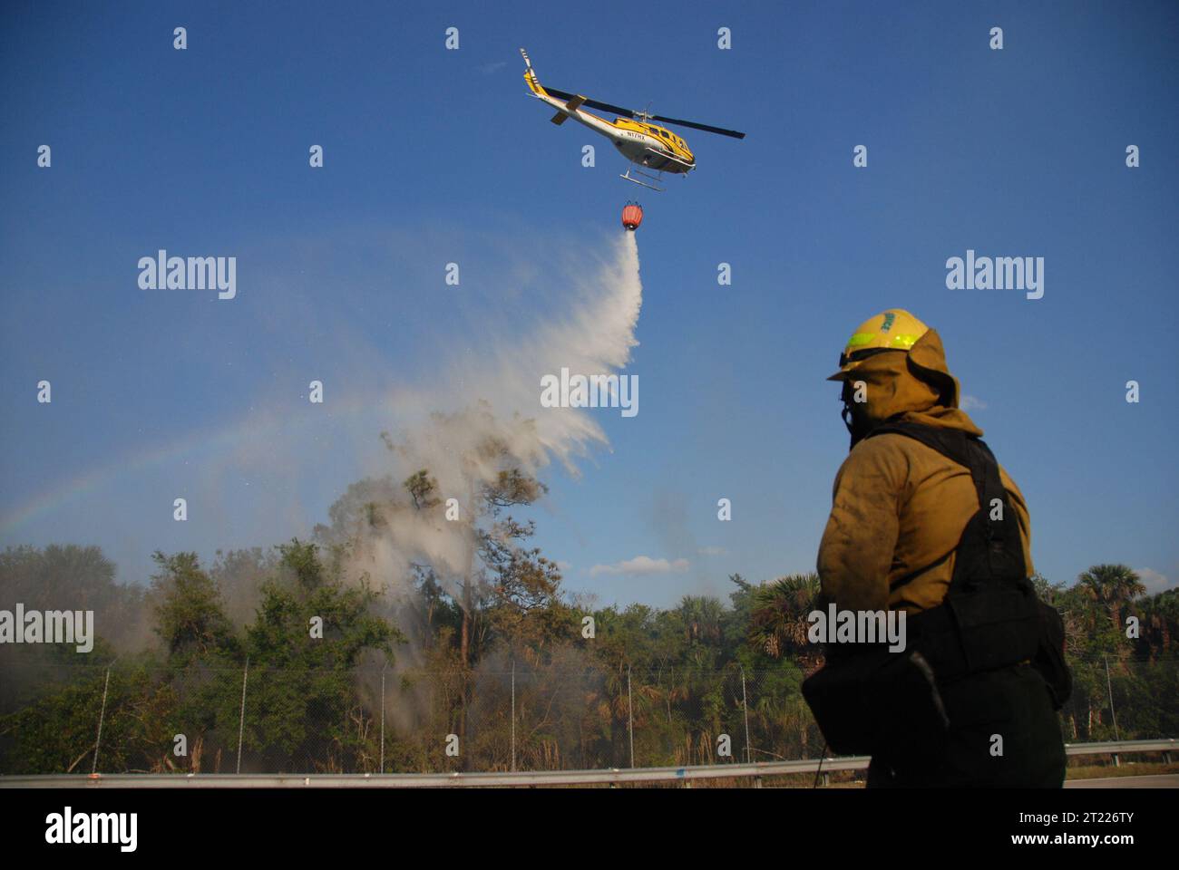 A helicopter crew works a hot spot on the Deep Fire at Florida Panther ...