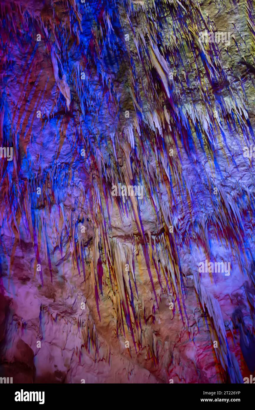 Karst cave, amazing view of stalactites and stalagnites in colorful ...