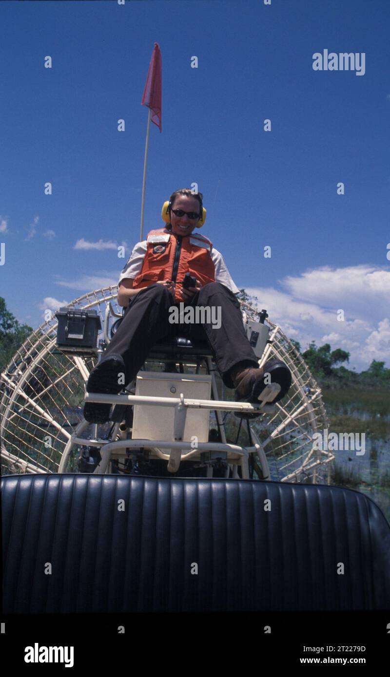 A FWS employee smiles for a picture while riding on an airboat ...