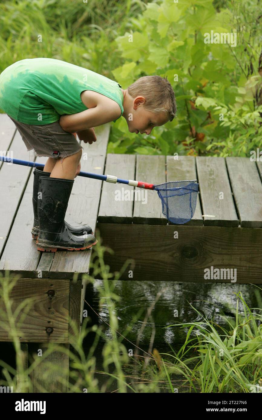 A boy observes critters in the water at Big Muddy National Fish and ...