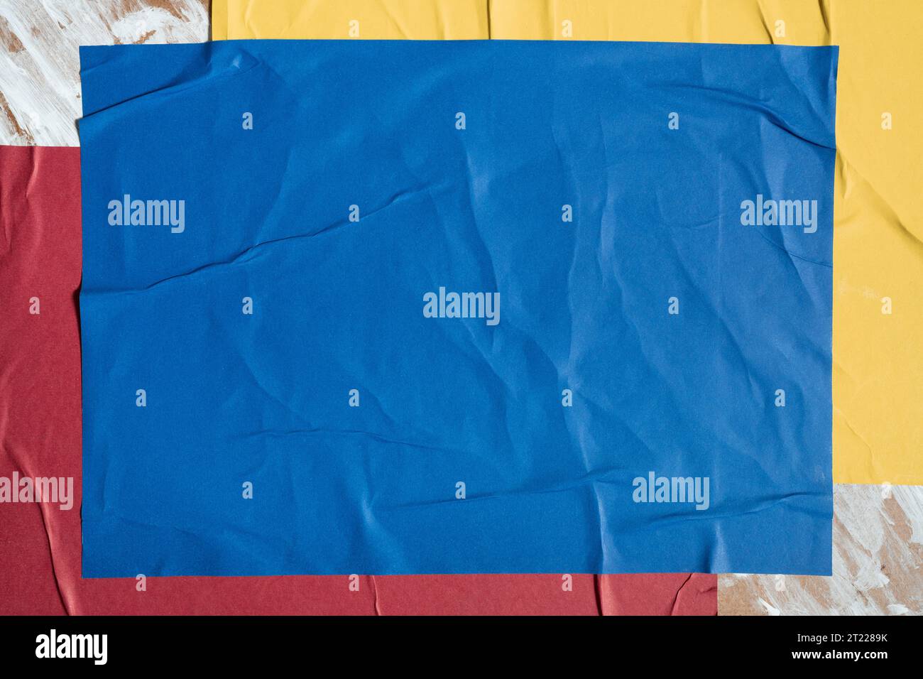 Blue wheat paste paper poster on red and yellow paper texture ...