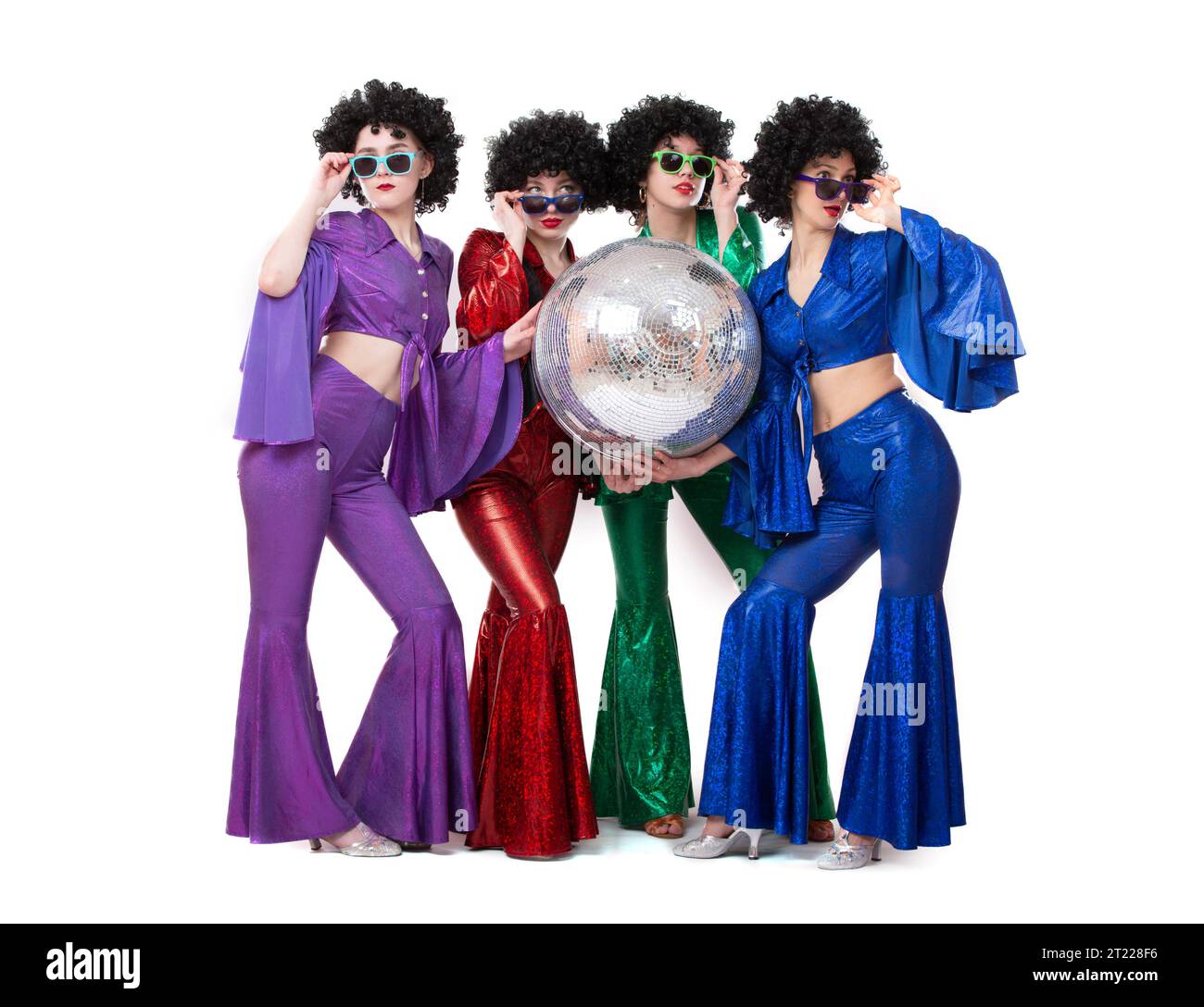 A group of girls in disco costumes are holding a disco ball and looking ...