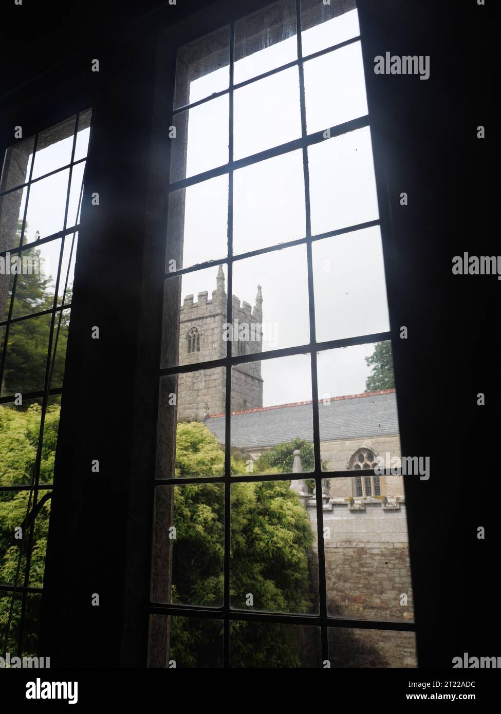View through a window to the church of the Victorian manor house of ...