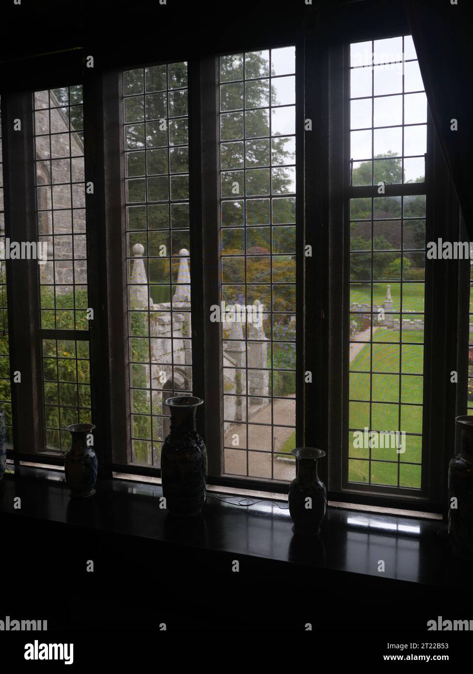 View through a window to the garden of Lanhydrock manor house in ...