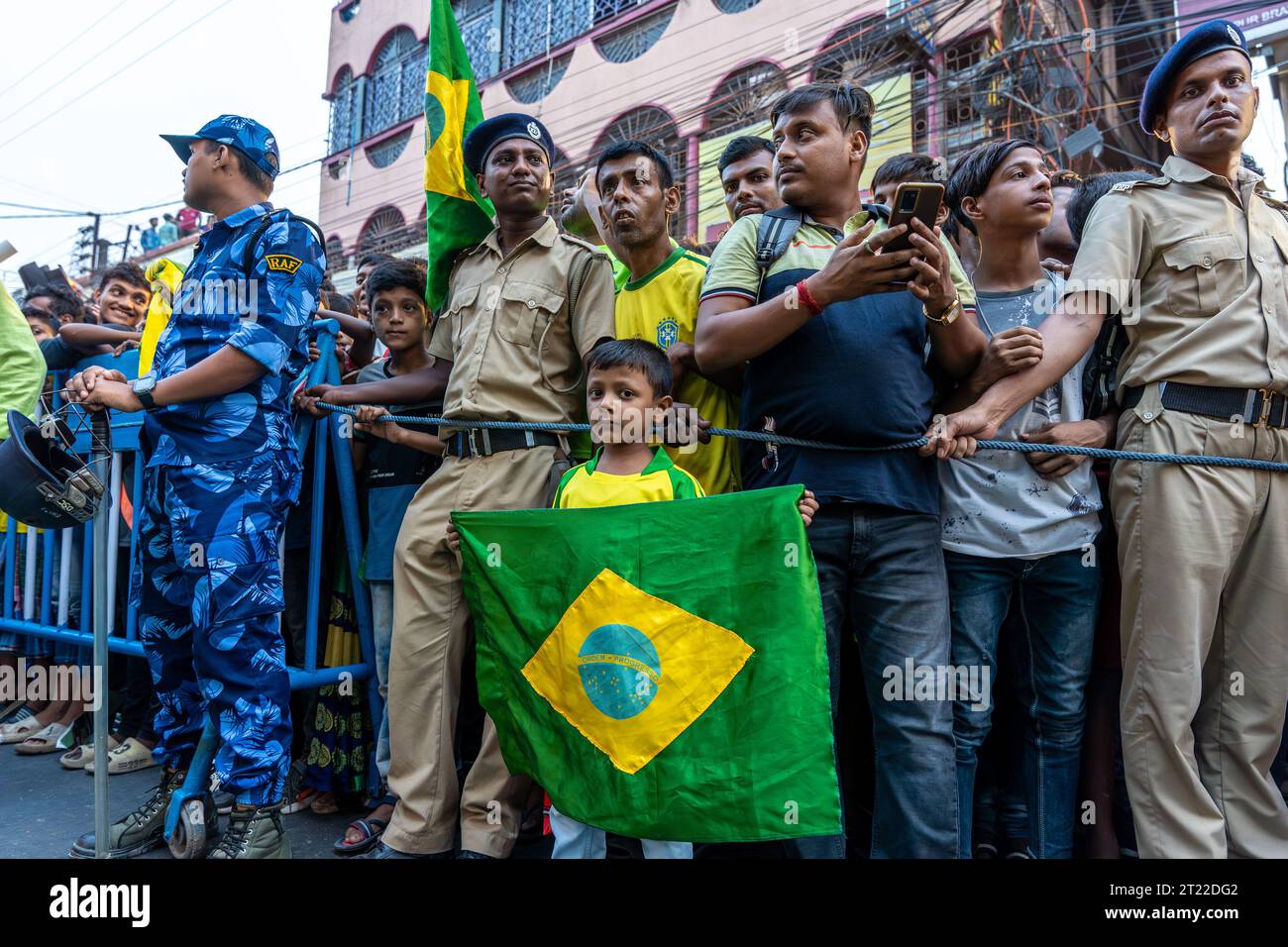 Kolkata, India. 16th Oct, 2023. A little Brazilian football fan holds ...