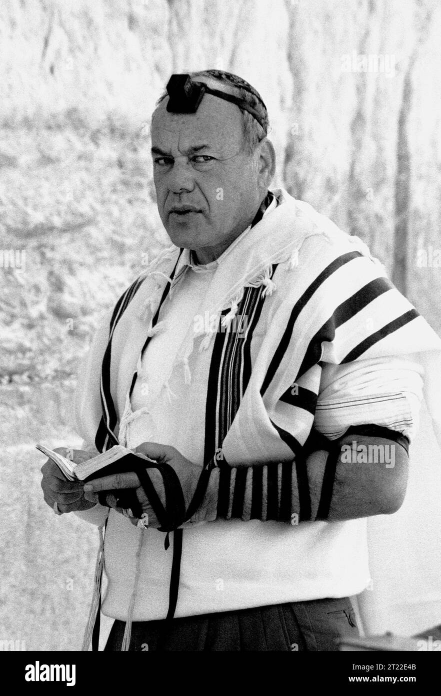 Israel, Jerusalem: man reads the Targum on the Wailing Wall. On his ...