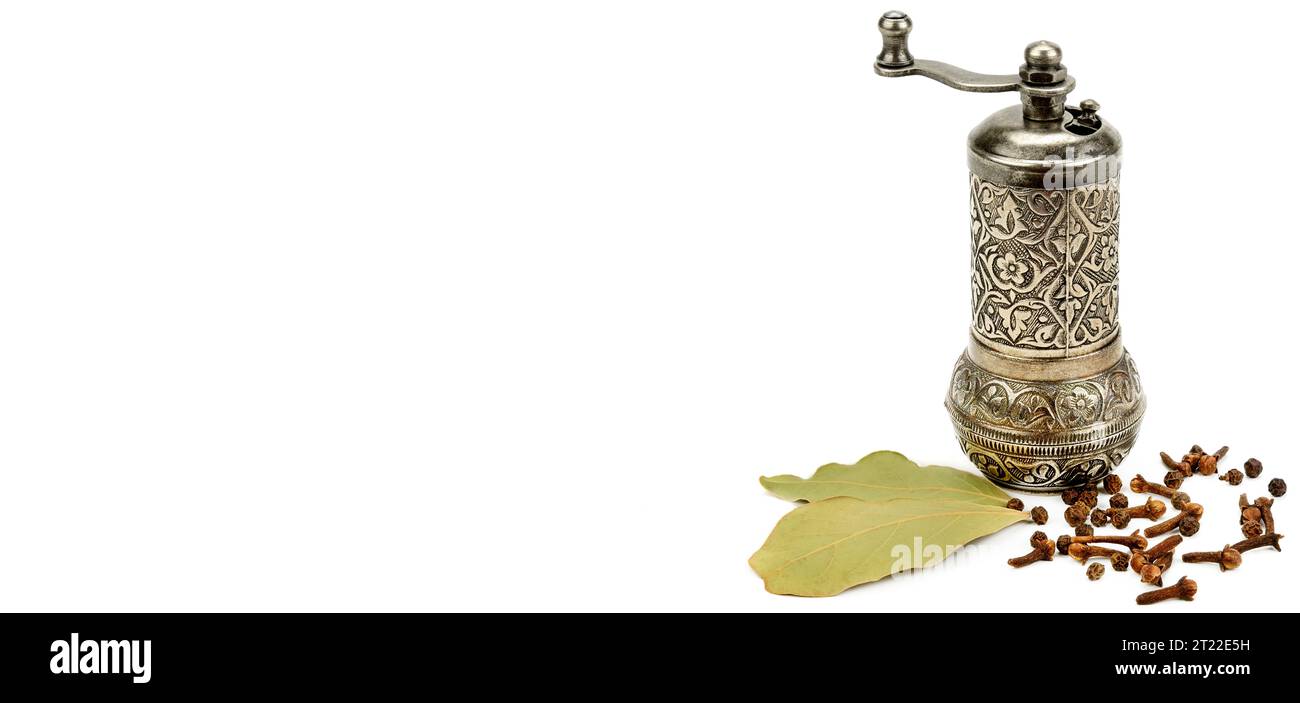 Manual grinder, clove spice and laurel isolated on white background ...