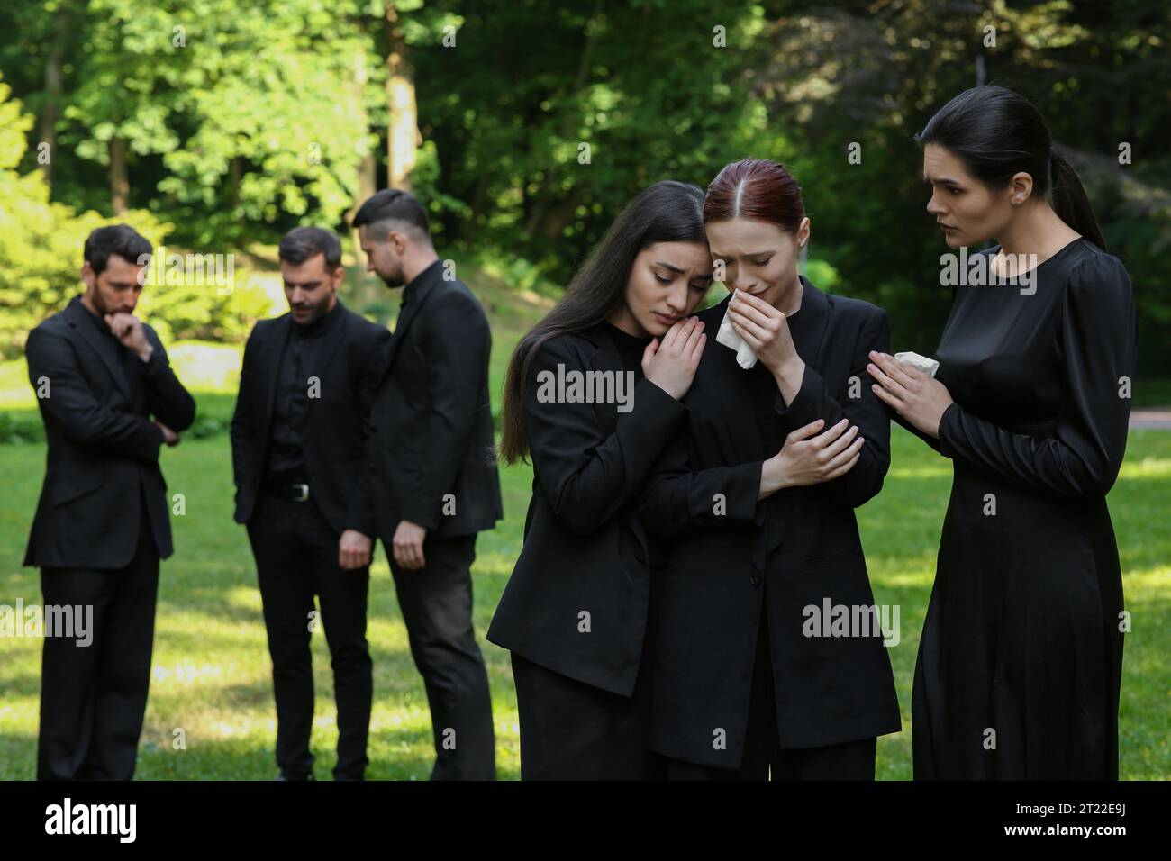 Sad people in black clothes mourning outdoors. Funeral ceremony Stock ...