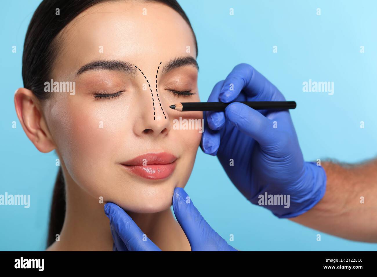 Woman preparing for cosmetic surgery, light blue background. Doctor ...