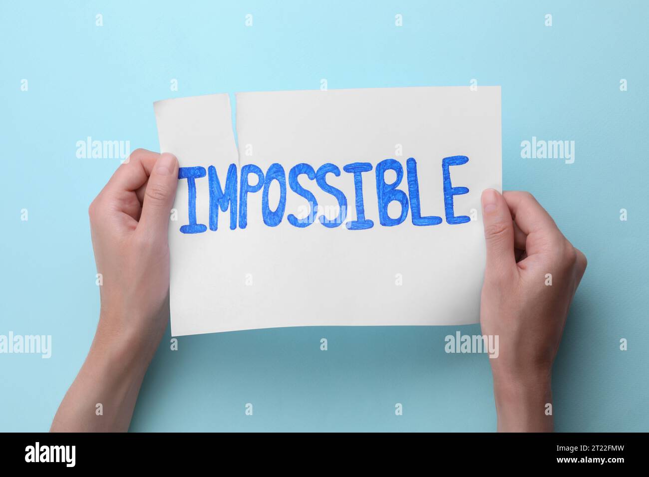 Motivation concept. Woman making word Possible from Impossible by ...