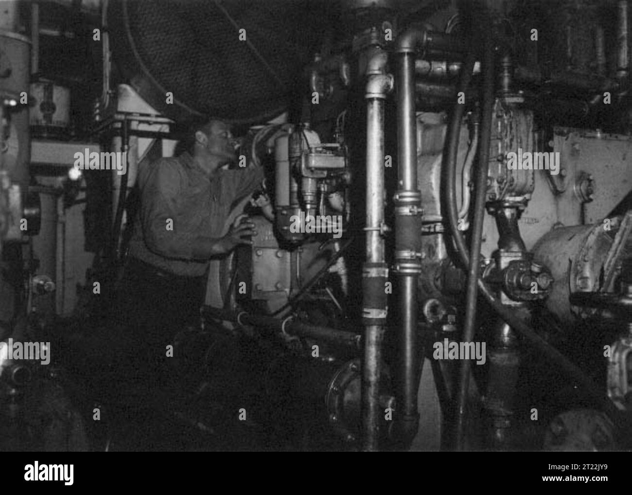 Bering Sea; "Chief Engineer Al Kuehuel working on auxilliary engine ...