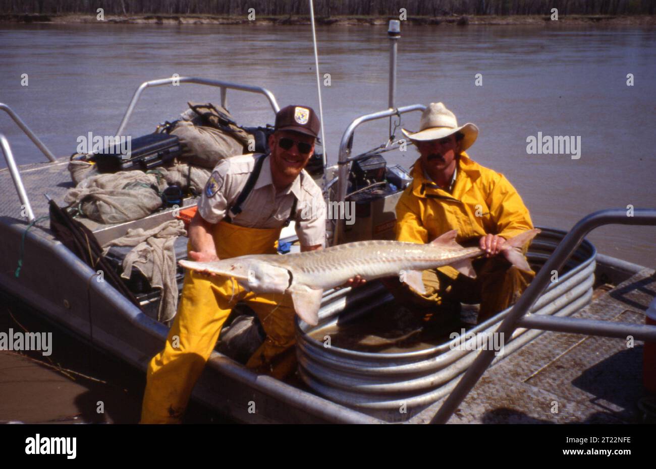 Two men (one FWS employee with uniform) in a boat on the Yellowstone ...