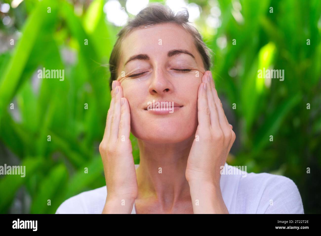 Close Up Photo Of A Middle Aged Woman Doing A Facial Massage Using 1184