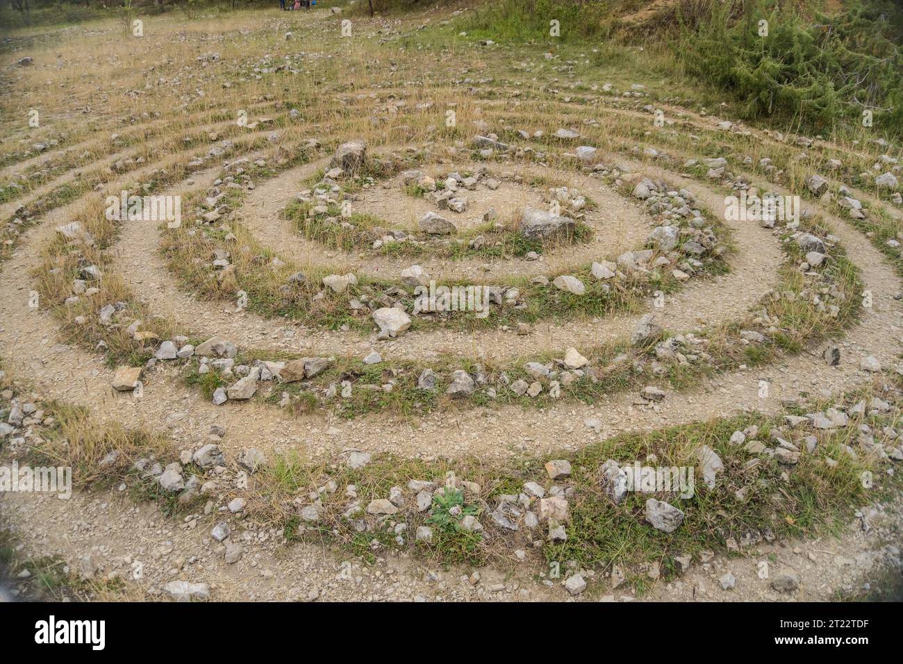 Circular labyrinths on the ground of grass and stones near the ...