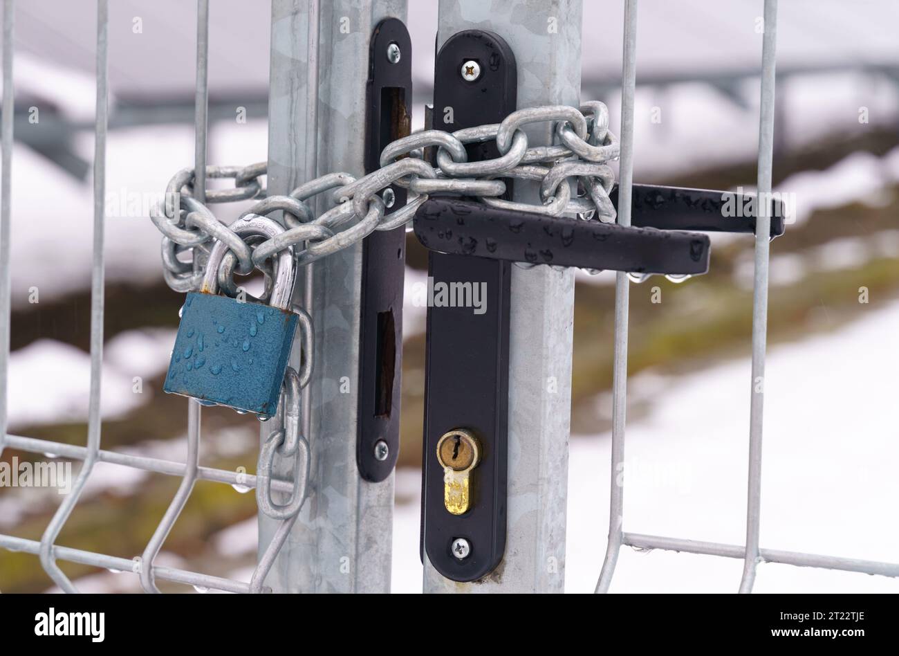 Metal gate closed with a chain to the castle Stock Photo - Alamy