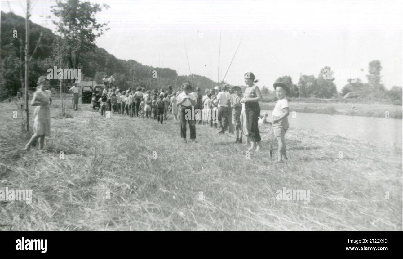 This image shows visitors at a fish hatchery, where they observe and ...