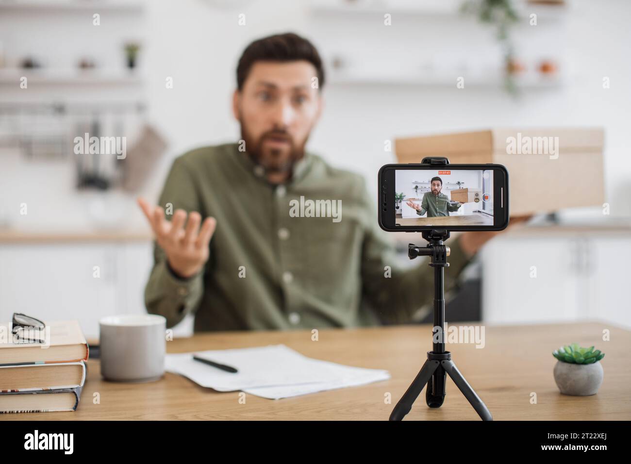 Caucasian bearded man making surprised facial expression while ...