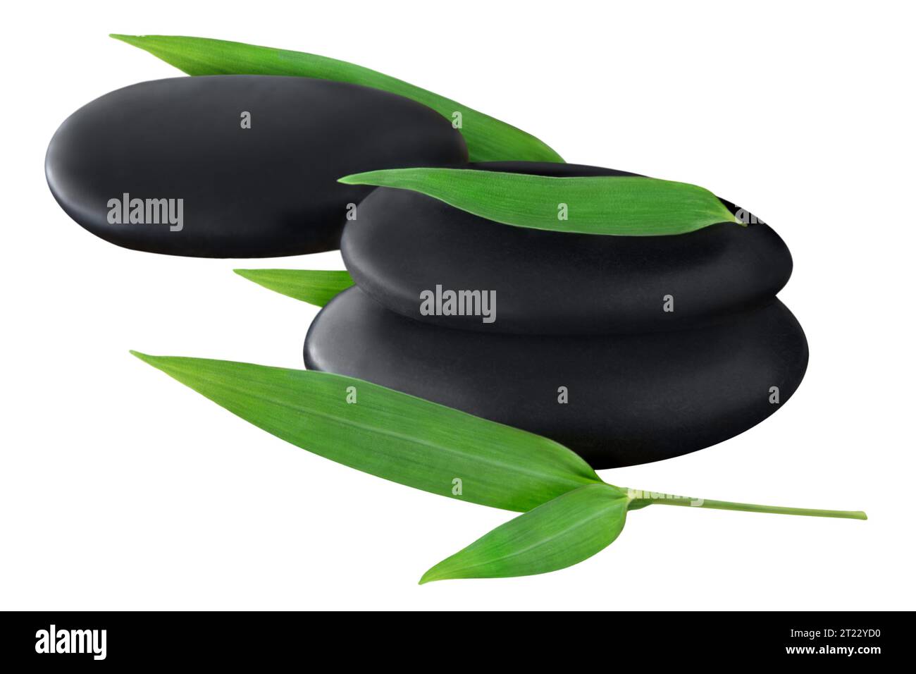 3 black healing hot stones and bamboo leaves isolated on white ...