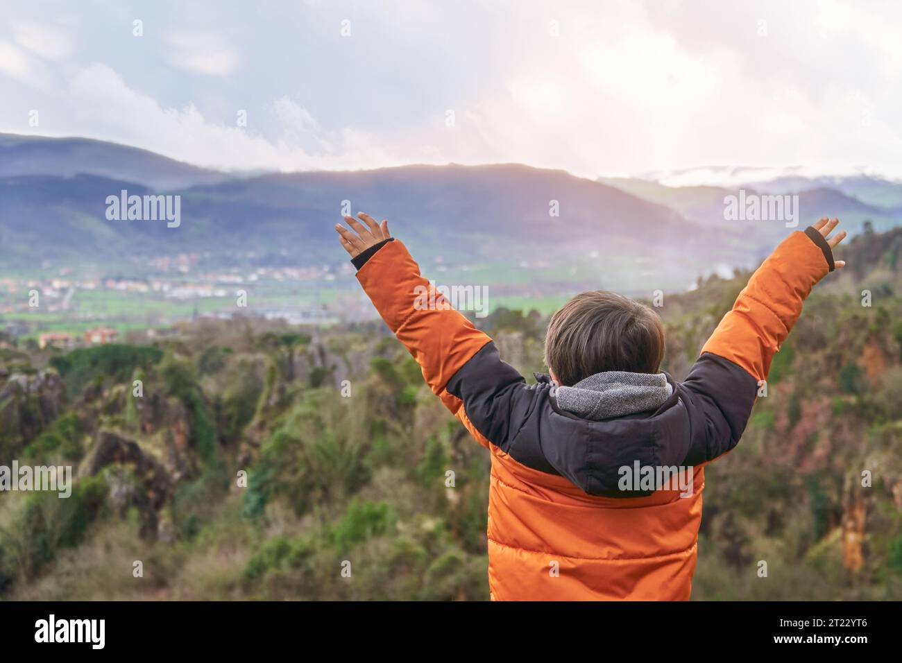happy kid with arms up on a winter trip to the mountains Stock Photo ...