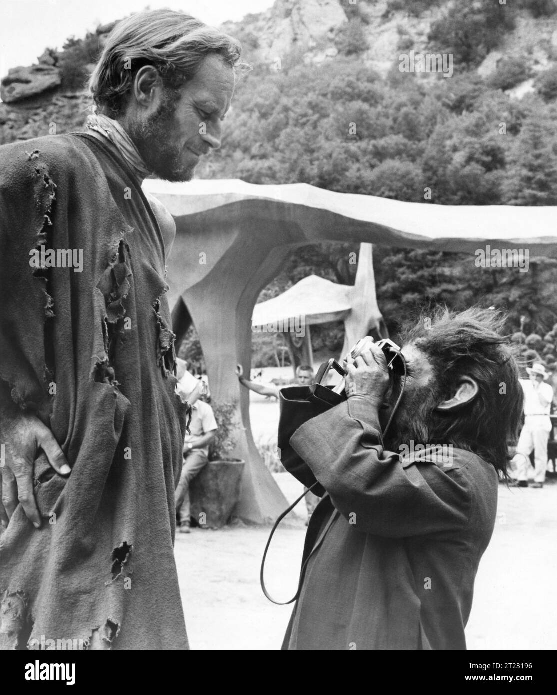 CHARLTON HESTON being photographed by an ape extra on the Ape City set ...