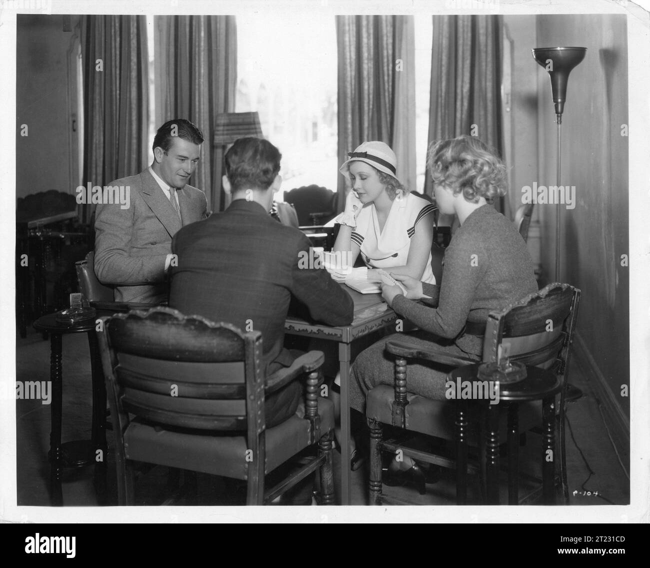 JOHN WAYNE and HELEN TWELVETREES playing Bridge at a Hollywood Club in ...
