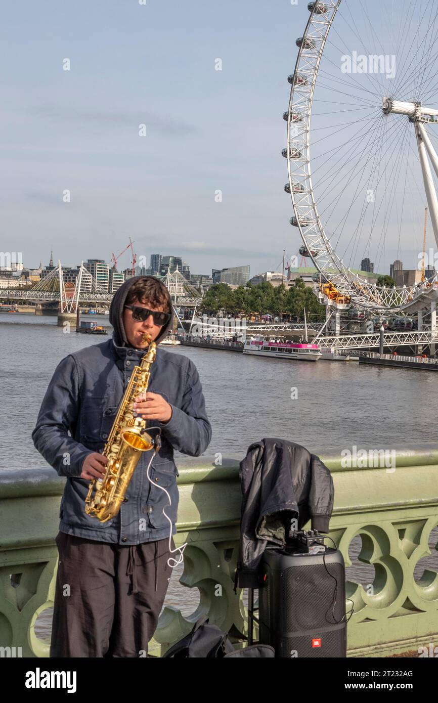 Busker playing saxophone on Westminster Bridge, London Stock Photo - Alamy
