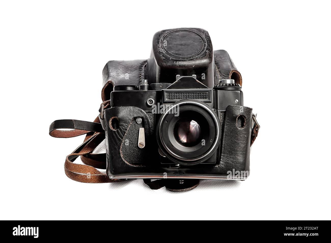 Old film SLR camera in a worn leather case on a white background ...