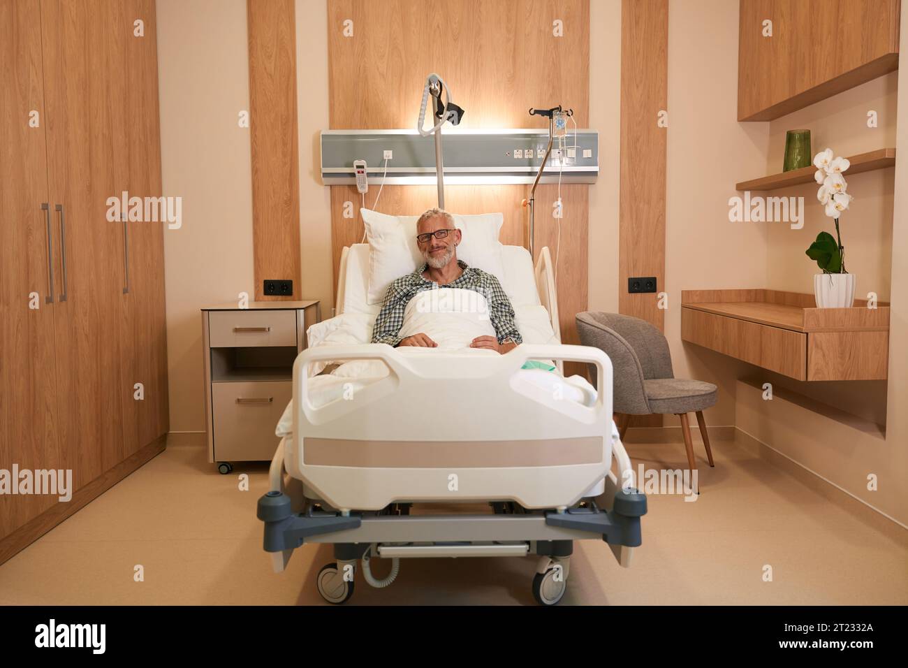 Old man settled comfortably in the hospital room Stock Photo - Alamy