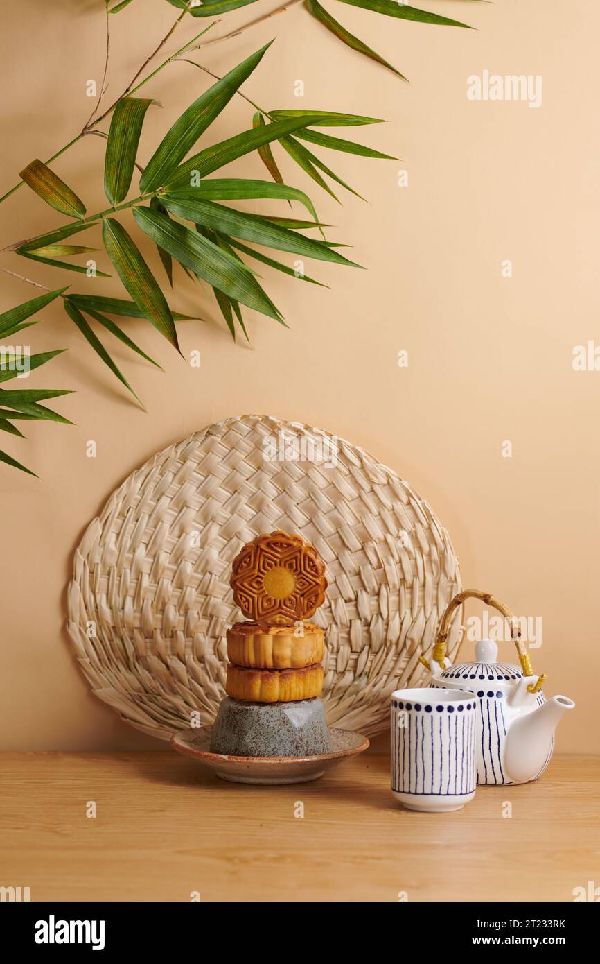 Stack of traditional moon cakes, teapot and cup prepared of mid-autumn ...