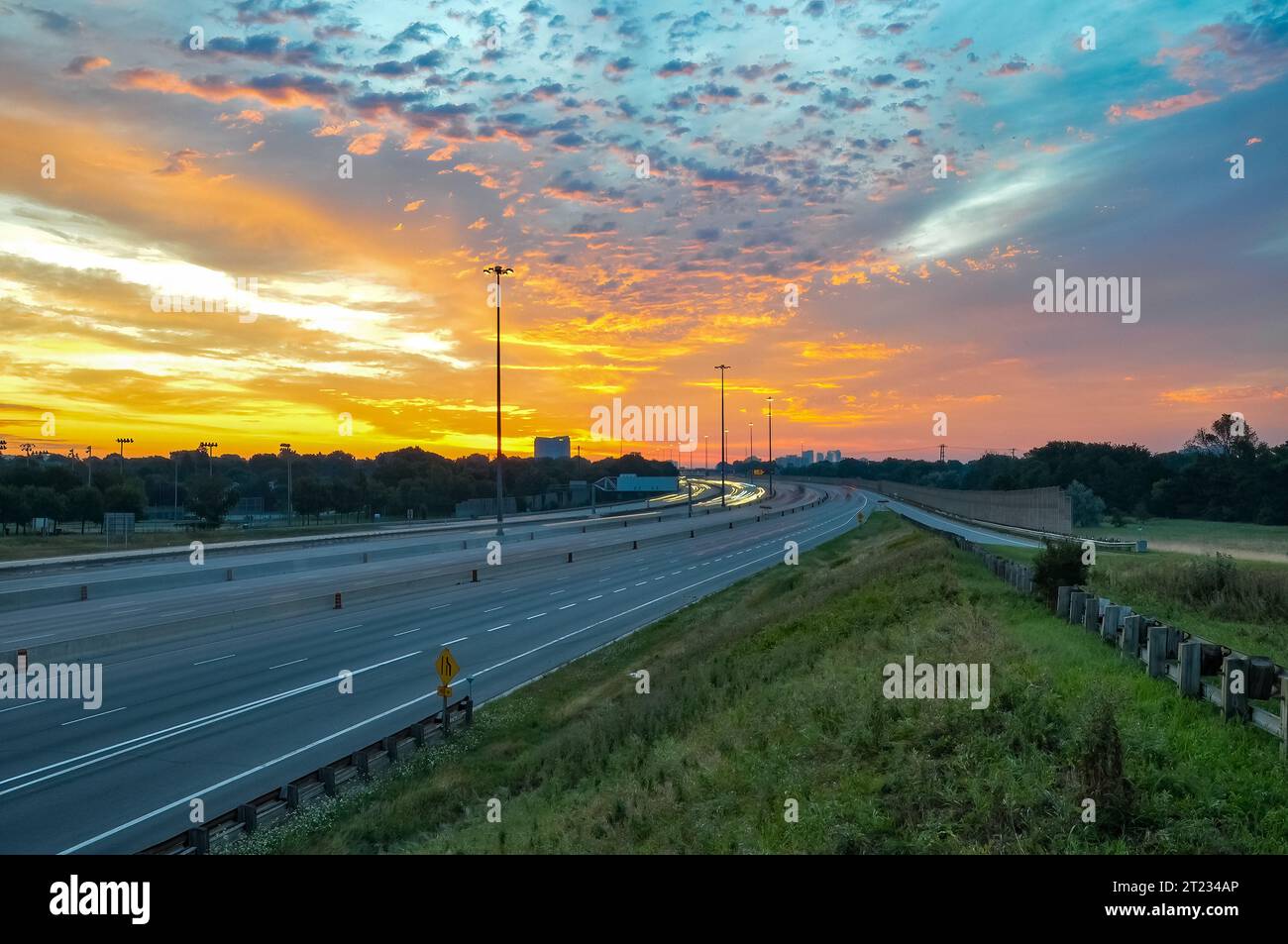 Sunrise or dawn sky on Ontario Highway 401. The speedway is officially ...