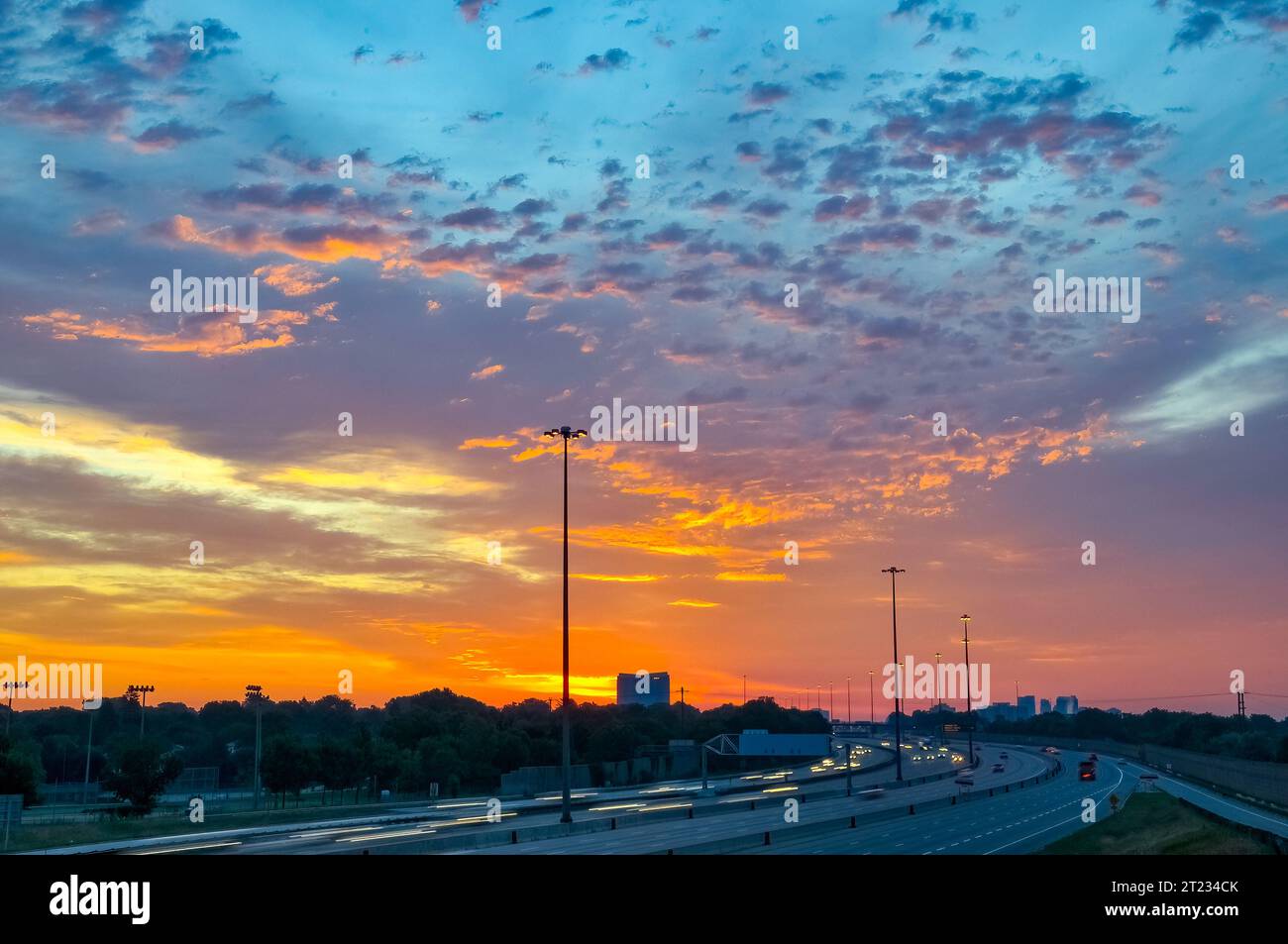 Sunrise or dawn sky on Ontario Highway 401. The speedway is officially ...
