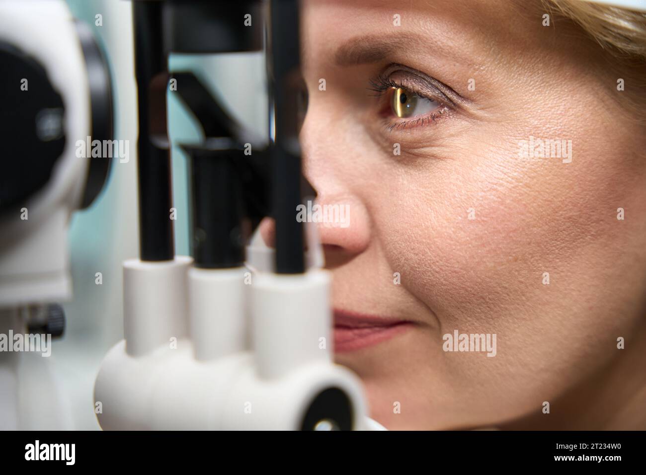 Client head is fixed in front of special ophthalmic device Stock Photo ...