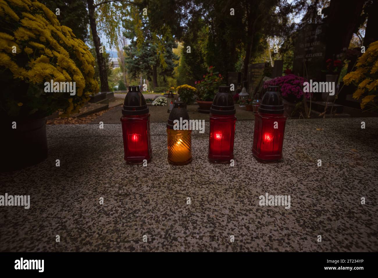 All souls day celebration in the cemetery, traditional christian decoration on tombstone ...