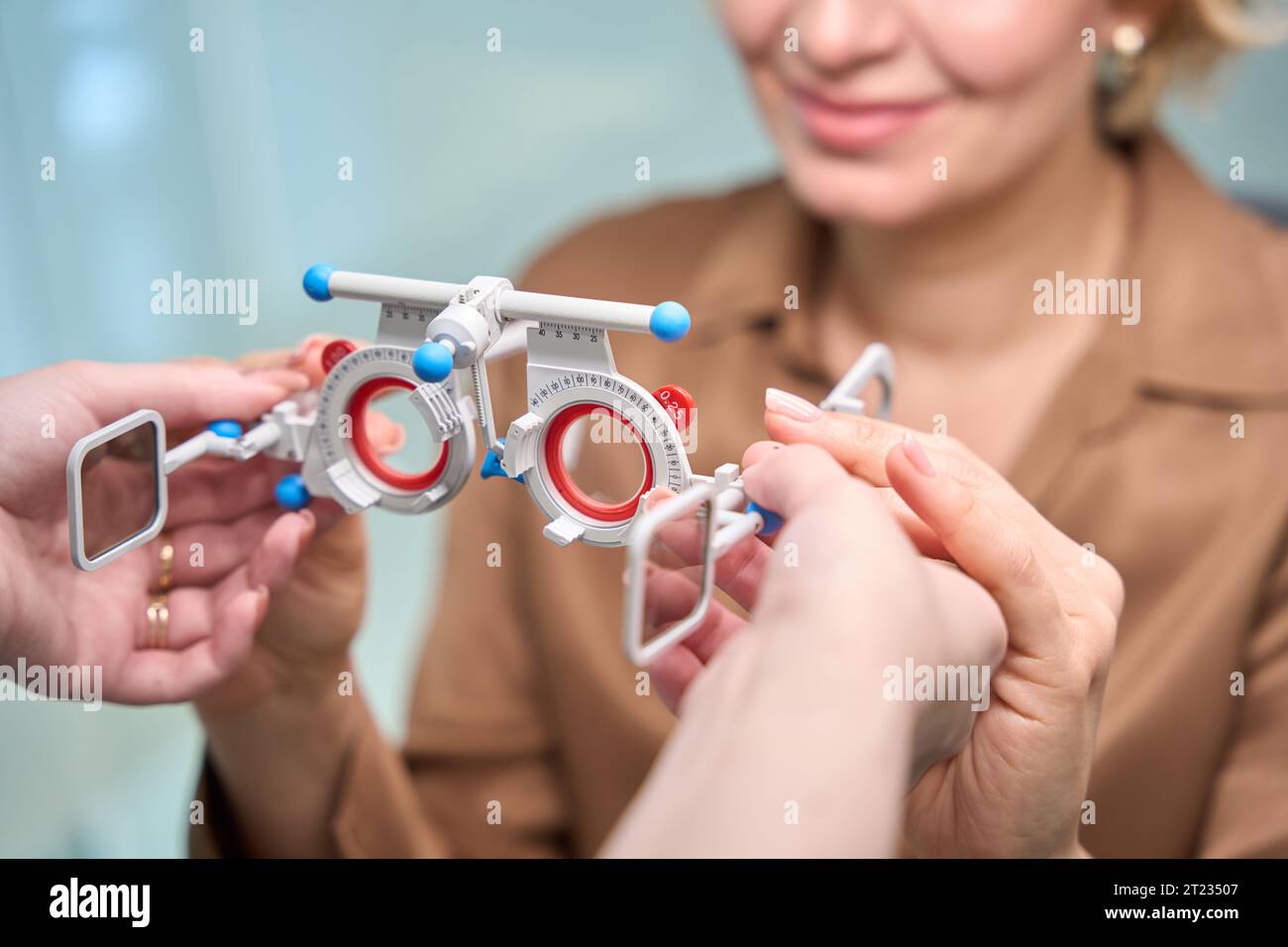 Employee of an optical salon uses professional device at work Stock ...