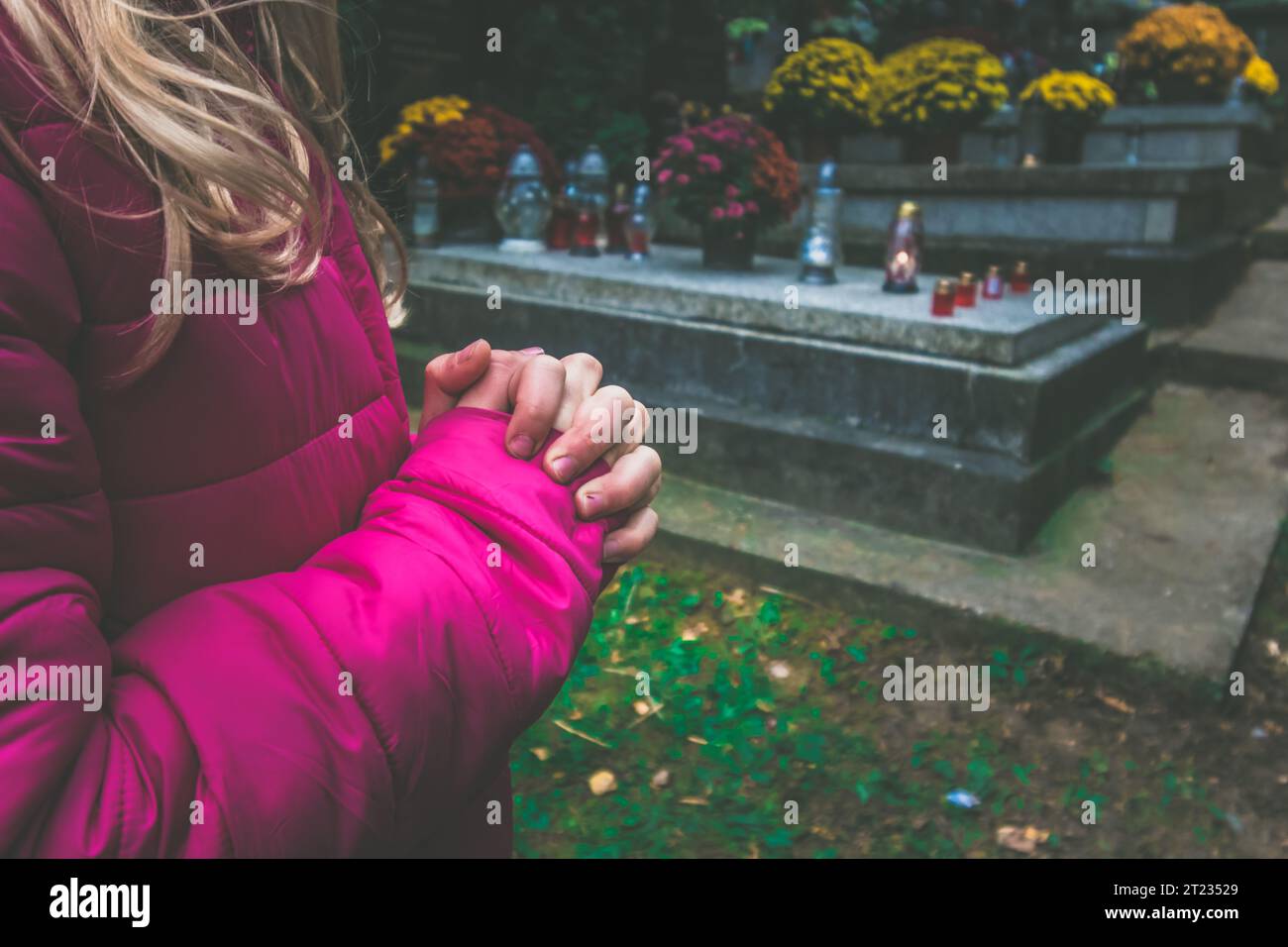 sad girl praying in the cemetery alone Stock Photo - Alamy