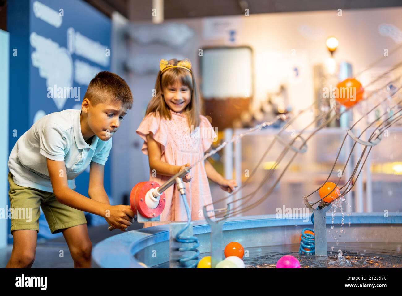 Little boy and girl playing in a science museum Stock Photo - Alamy