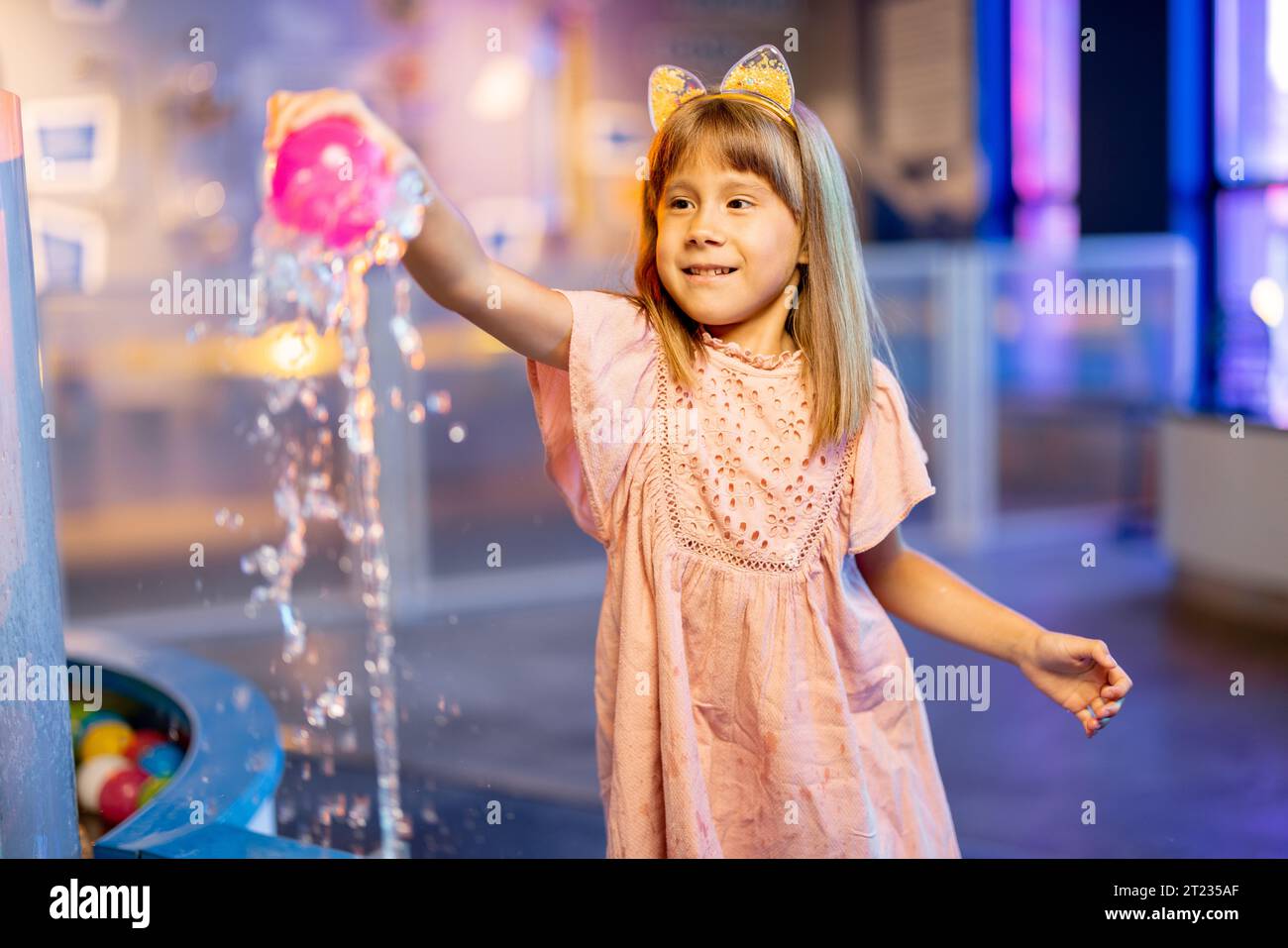 Little girl playing in a science museum Stock Photo - Alamy