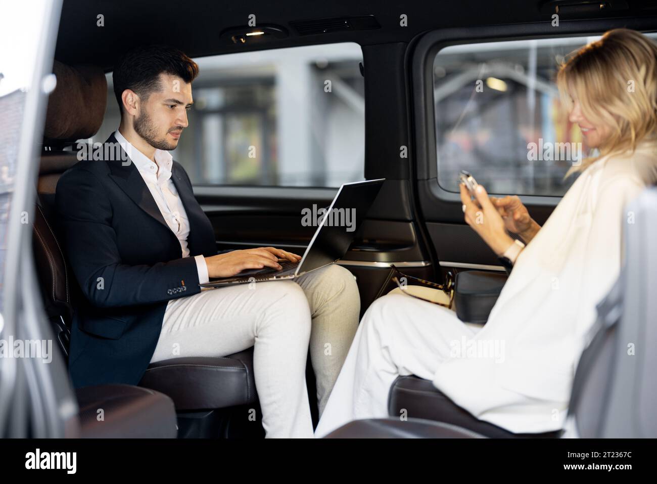 Business people sitting in minivan taxi Stock Photo - Alamy