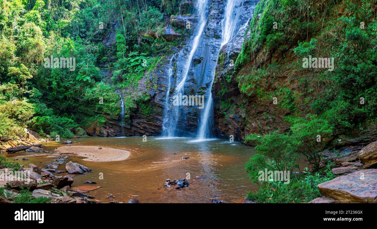 Waterfall flowing into a water well in the middle of the forest in the ...