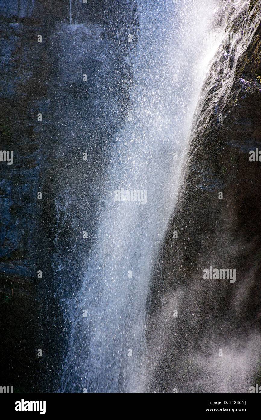 Waterfall splashing against rocks in sunlit waterfall in Minas Gerais ...