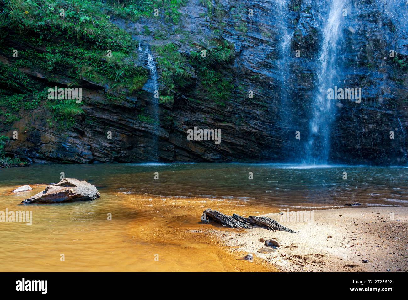 Waterfalls trickling down rocks into a small lake in Minas Gerais ...