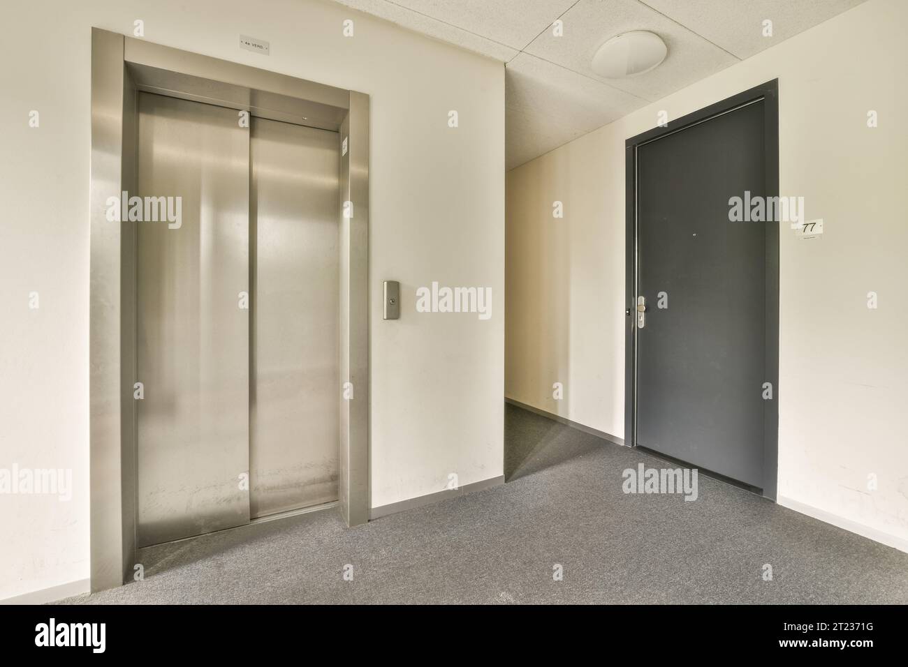 an empty office with two elevators in the middle and one on the other ...